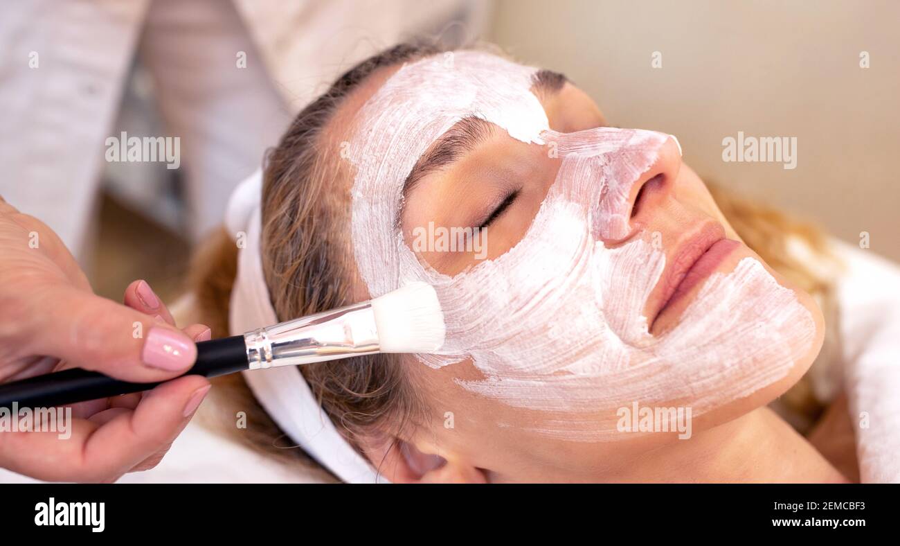 Facial skin repair and rejuvenation mask applied in a beauty salon ...