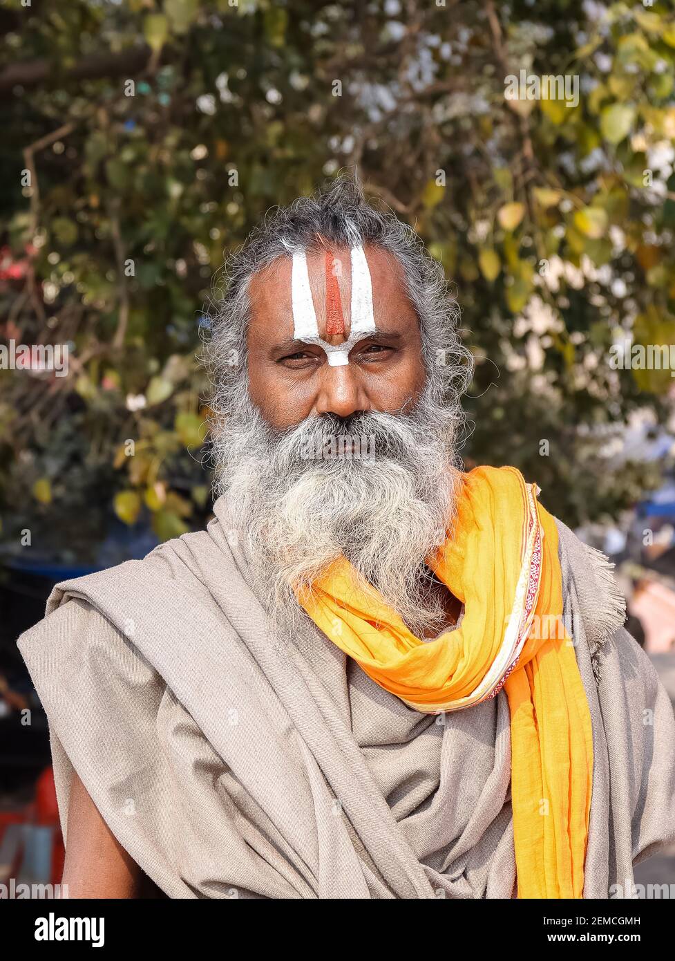 Indian Sadhu in traditional saffron dress participating in Kumbh ...