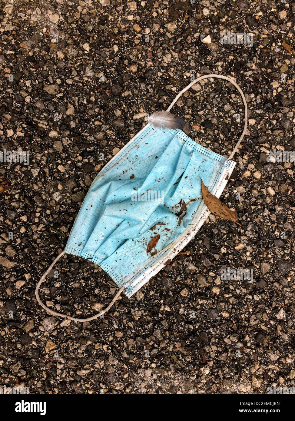 Used medical face mask thrown away, garbage on the street Stock Photo ...