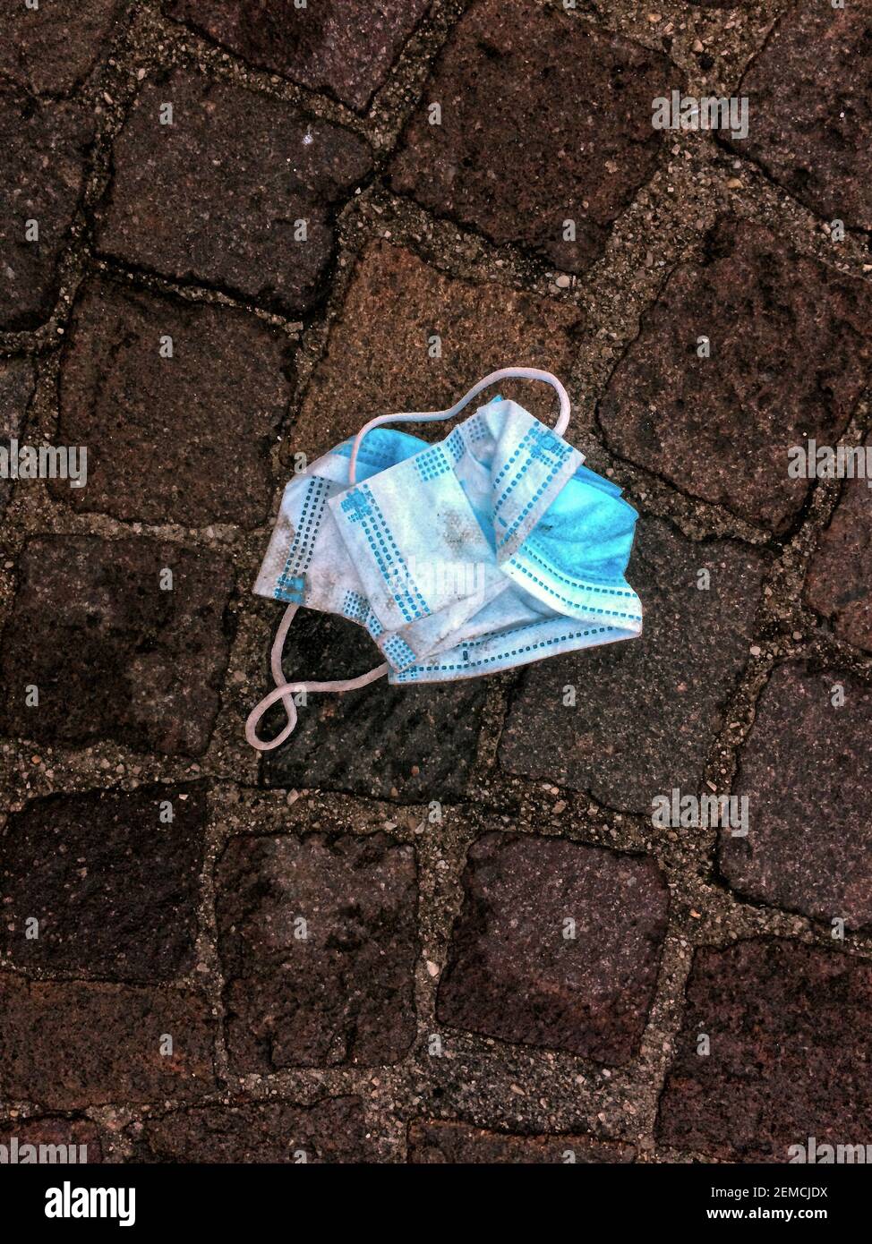 Used surgical face mask thrown away on a street floor Stock Photo - Alamy