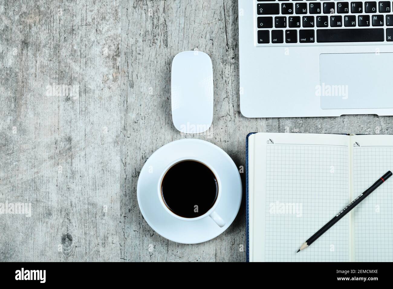 Notebook, laptop, mouse and a cup of tea on wooden desk Stock Photo - Alamy