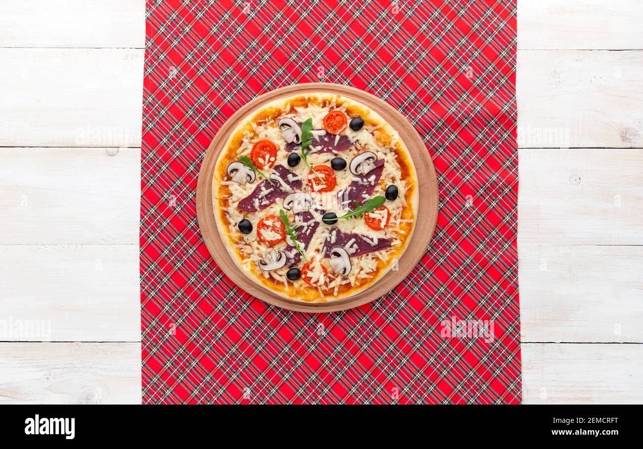 fresh pizza in a rustic Italian style with jerky olives mushrooms and ...