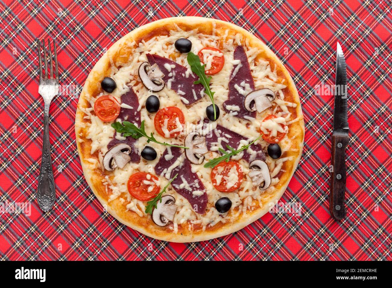 fresh pizza in a rustic Italian style with jerky olives mushrooms and ...