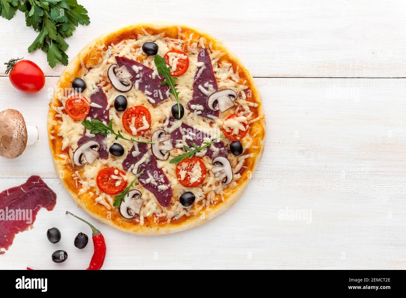 fresh pizza in a rustic Italian style with jerky olives mushrooms and ...