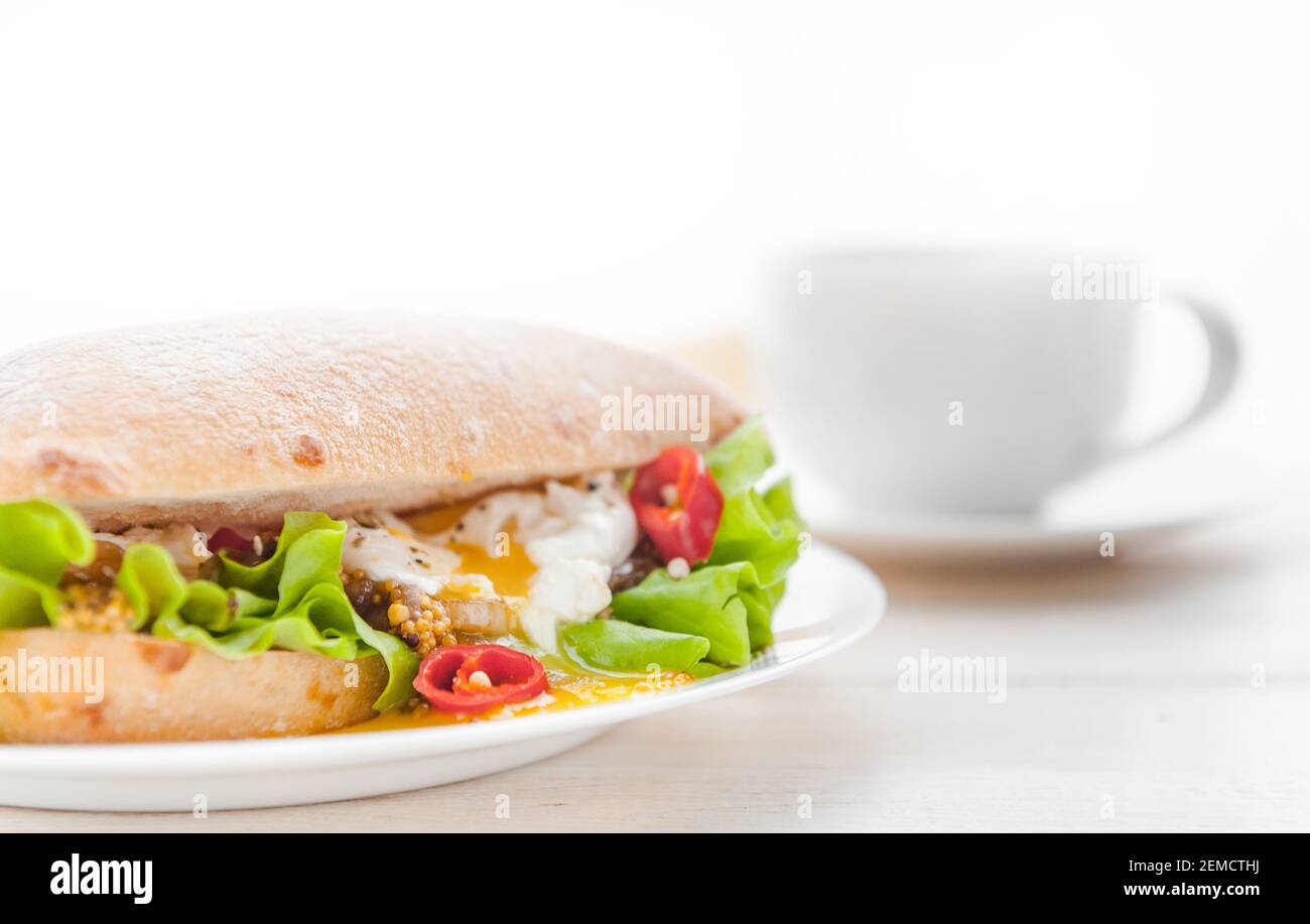breakfast in a rustic style on a white wooden surface. ciabatta with ...