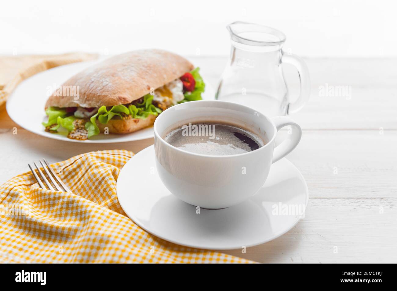 breakfast in a rustic style on a white wooden surface. ciabatta with ...