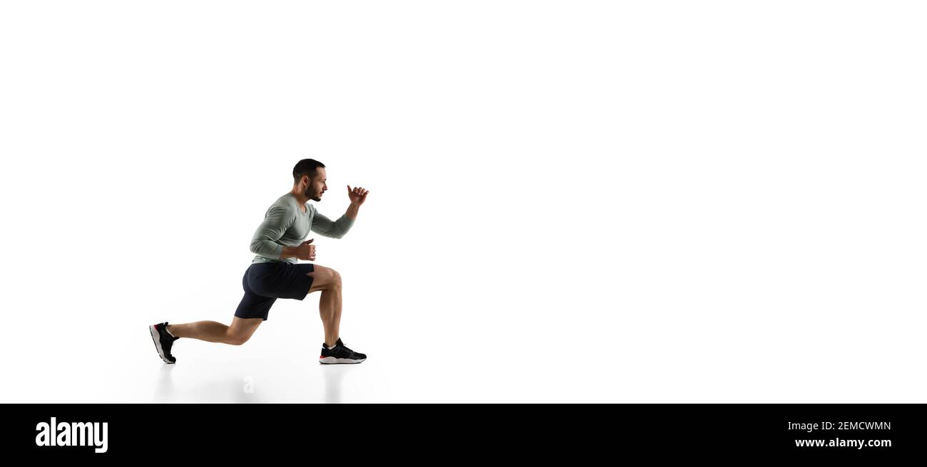 Flyer. Young caucasian male model in action, motion on white background ...