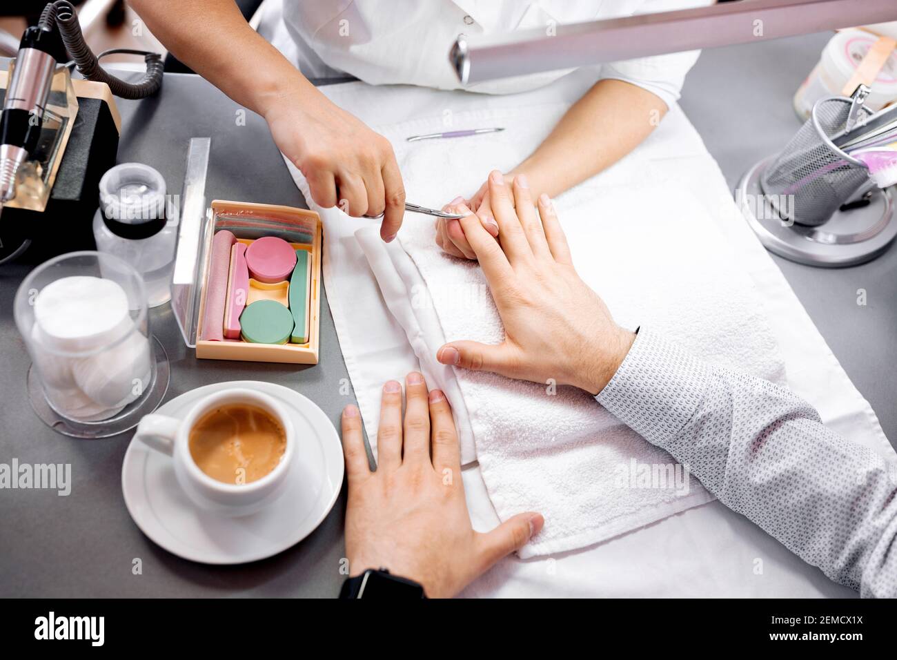 Cutting of stubborn cuticles with scissors in nail saloon Stock Photo ...