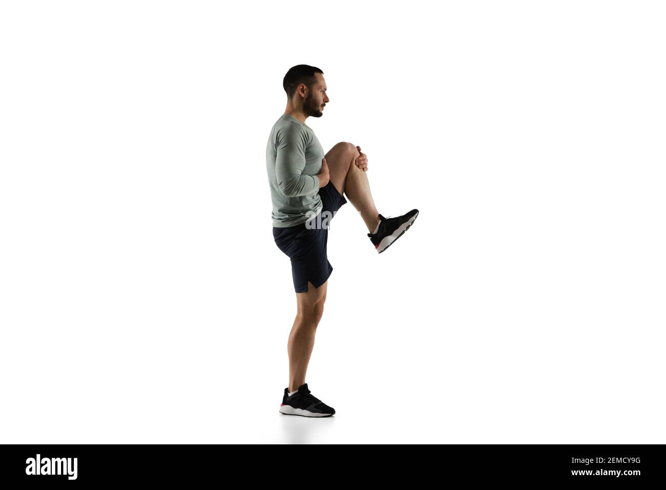 Stretching. Young caucasian male model in action, motion isolated on ...