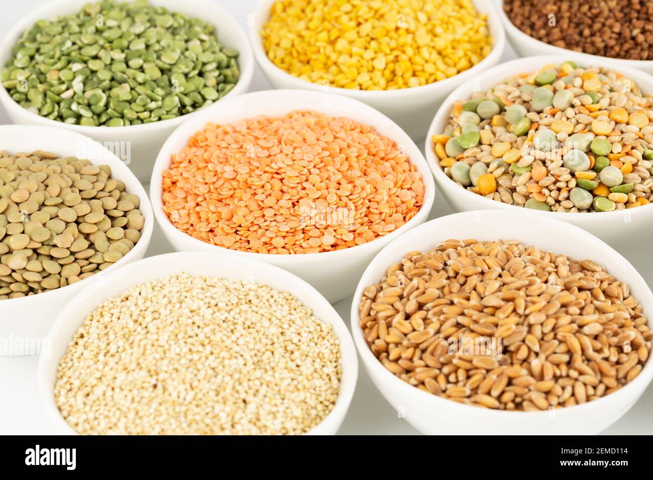 The collection of different groats in the white ceramic bowls. Split ...