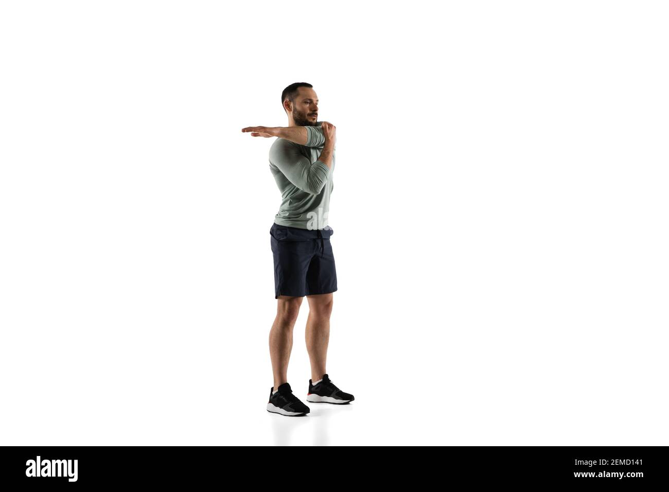 Stretching. Young caucasian male model in action, motion isolated on ...
