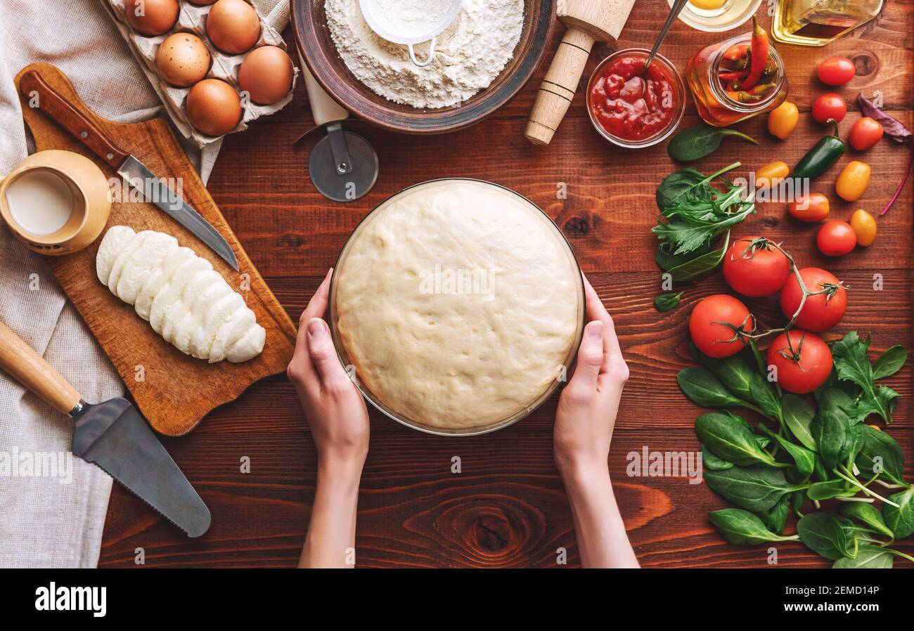 Step-by-step boss makes a pizza margarita. Dough and pizza ingredients ...