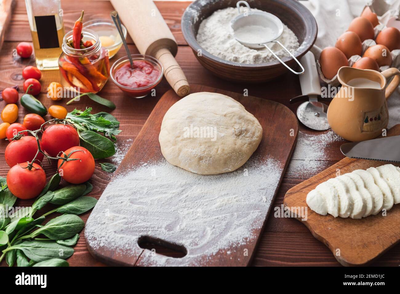 Step-by-step boss makes a pizza margarita. Dough and pizza ingredients ...