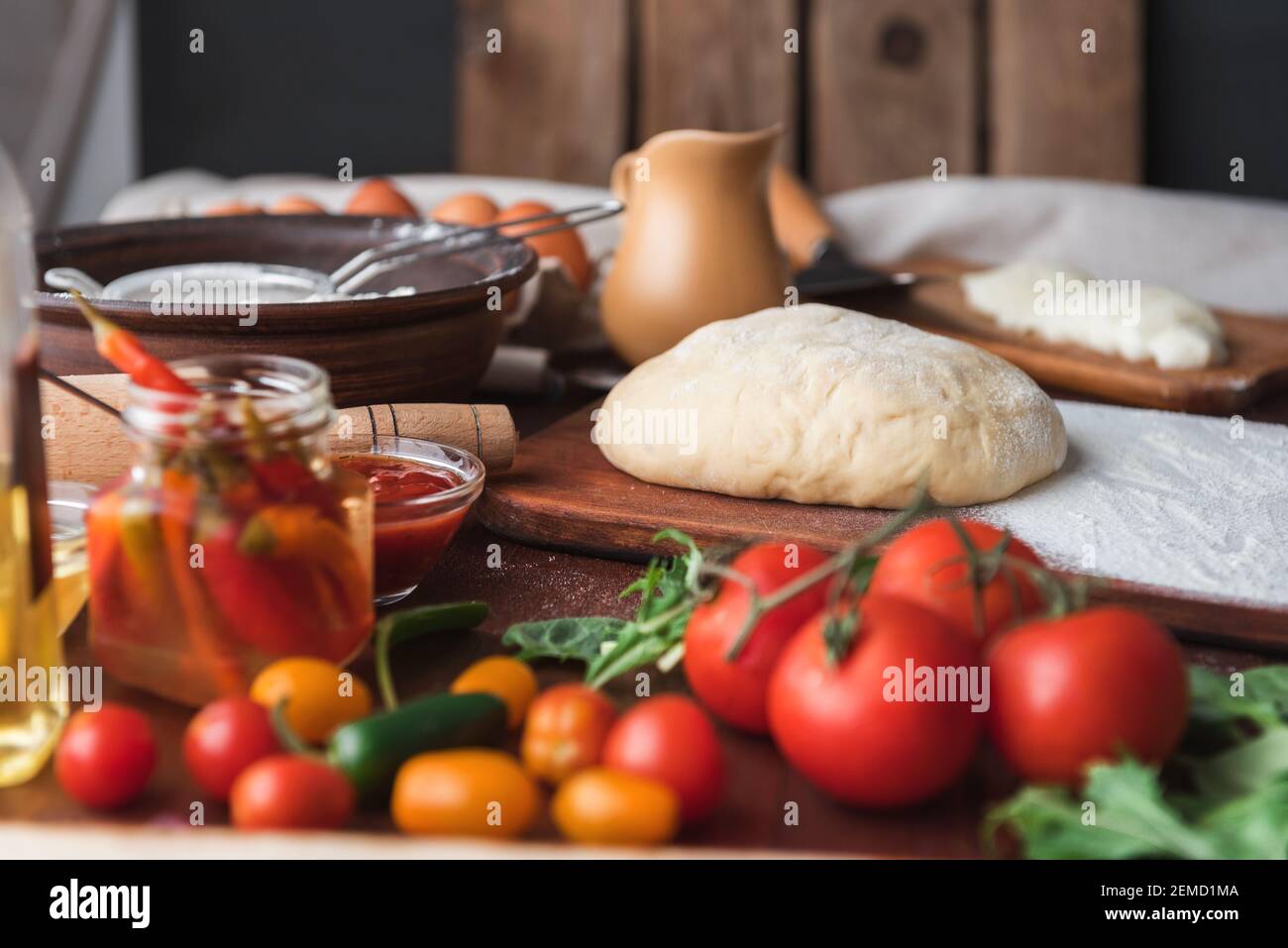 Step-by-step boss makes a pizza margarita. Dough and pizza ingredients ...