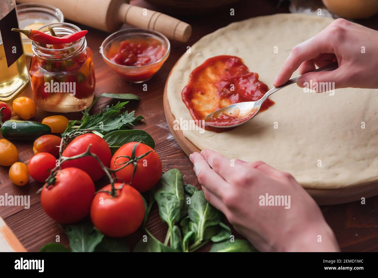 Step-by-step boss makes a pizza margarita. Dough and pizza ingredients ...
