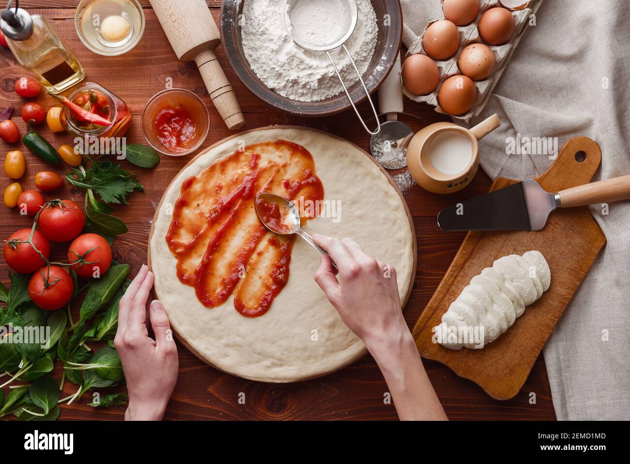 Step-by-step boss makes a pizza margarita. Dough and pizza ingredients ...