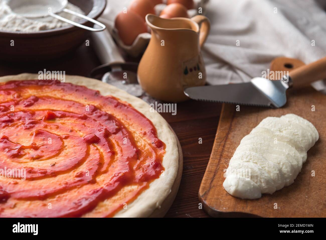 Step-by-step boss makes a pizza margarita. Dough and pizza ingredients ...