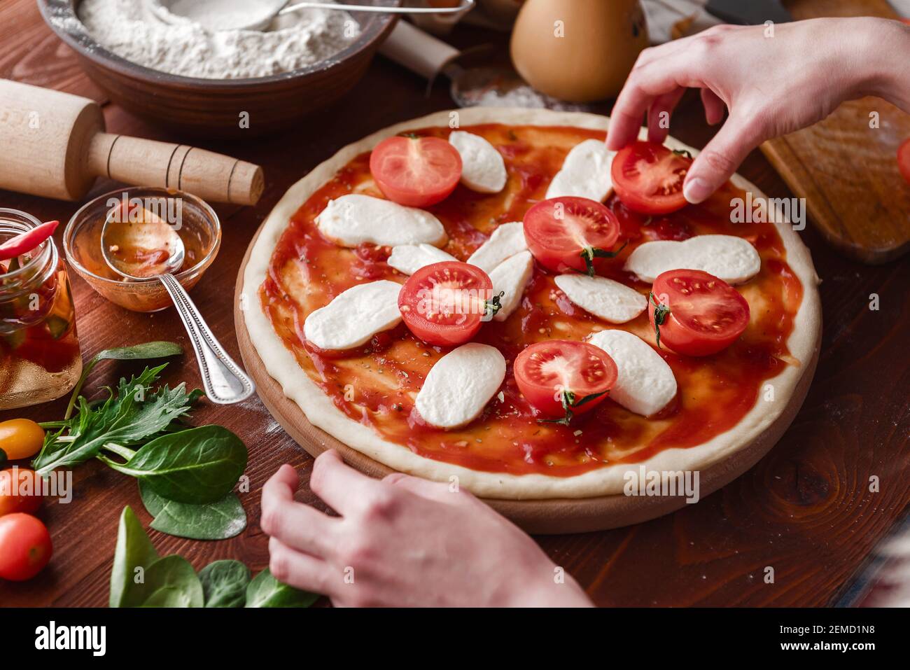 Step-by-step boss makes a pizza margarita. Dough and pizza ingredients ...