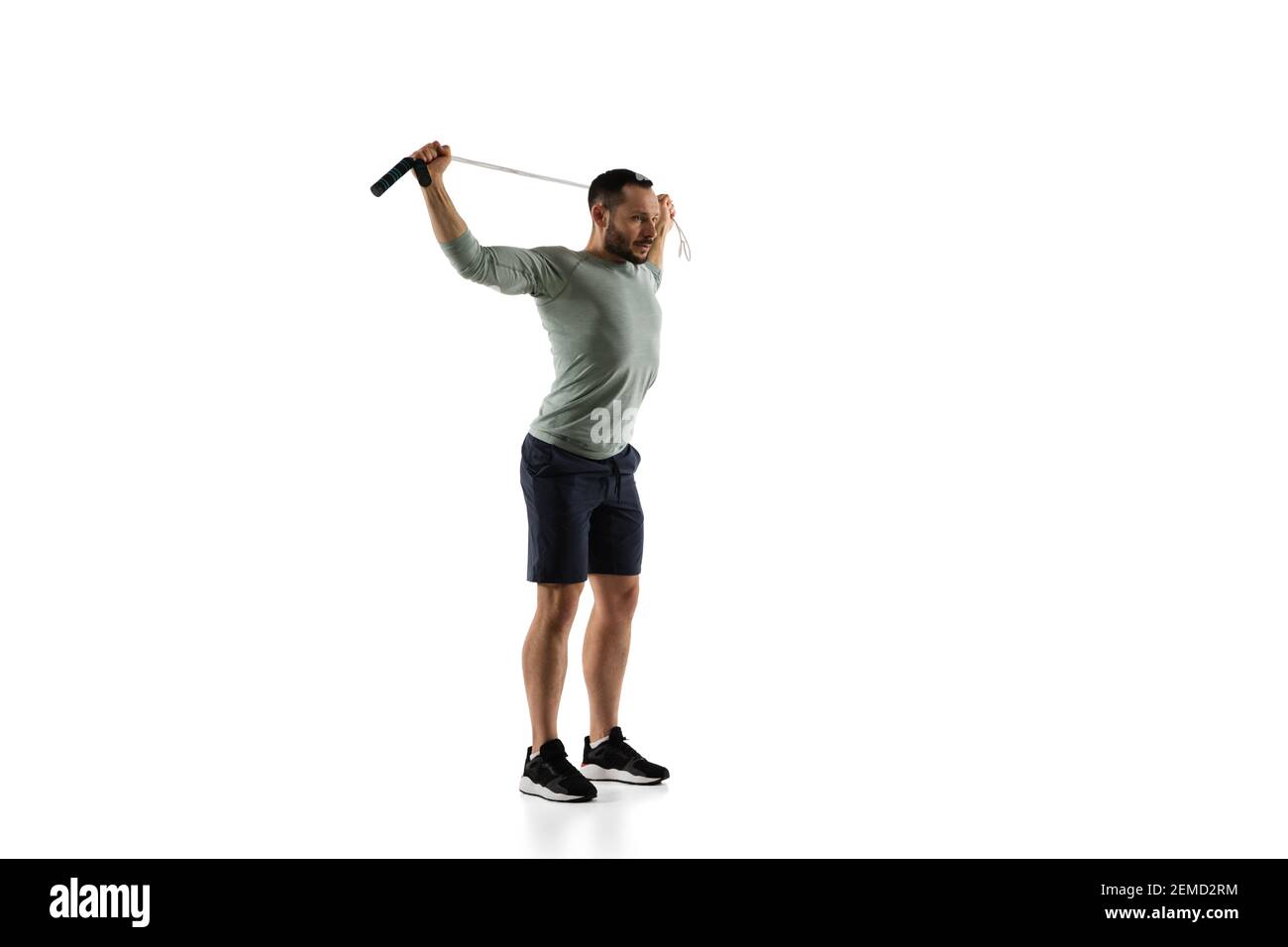 Jumping-rope. Young caucasian male model in action, motion on white ...