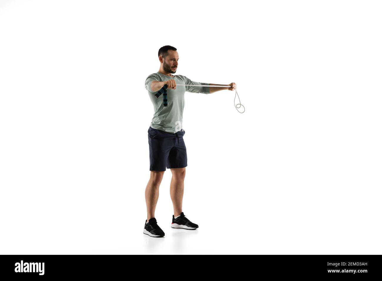 Jumping-rope. Young caucasian male model in action, motion on white ...