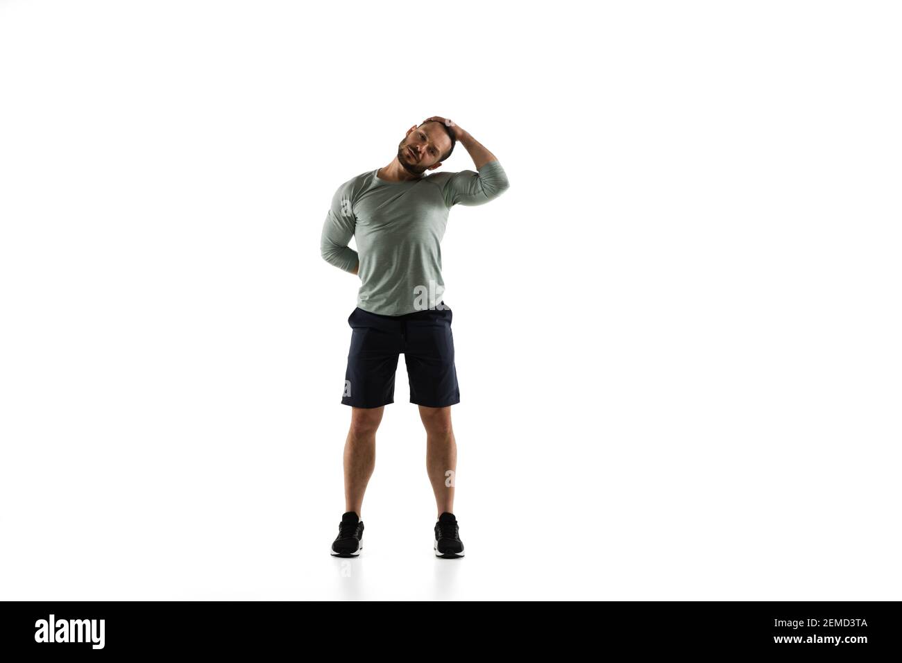 Stretching. Young caucasian male model in action, motion isolated on ...