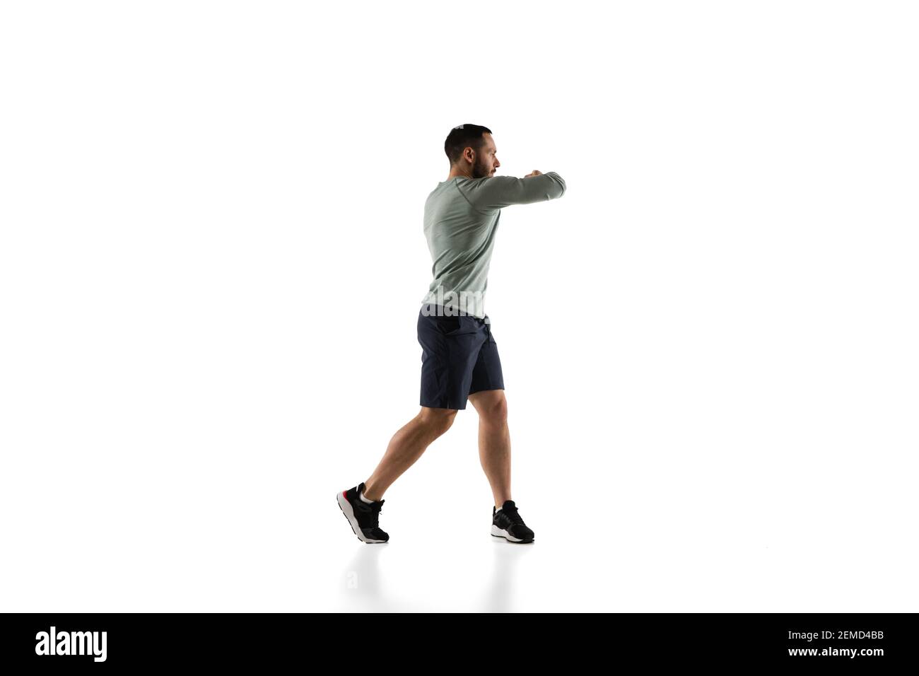Stretching. Young caucasian male model in action, motion isolated on ...