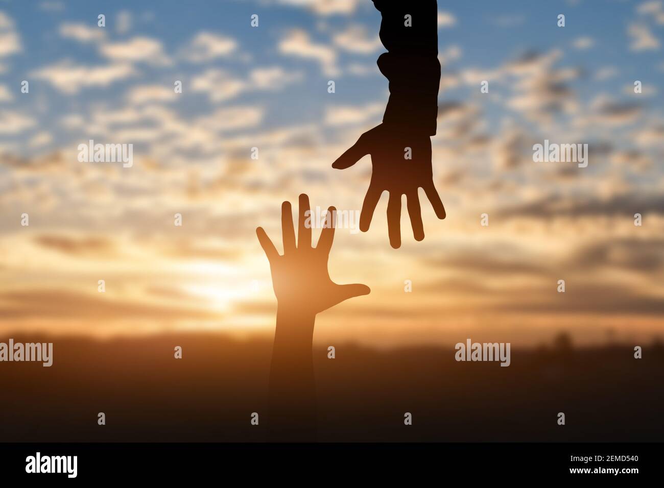 Silhouette of reaching, giving a helping hand, hope and support each ...
