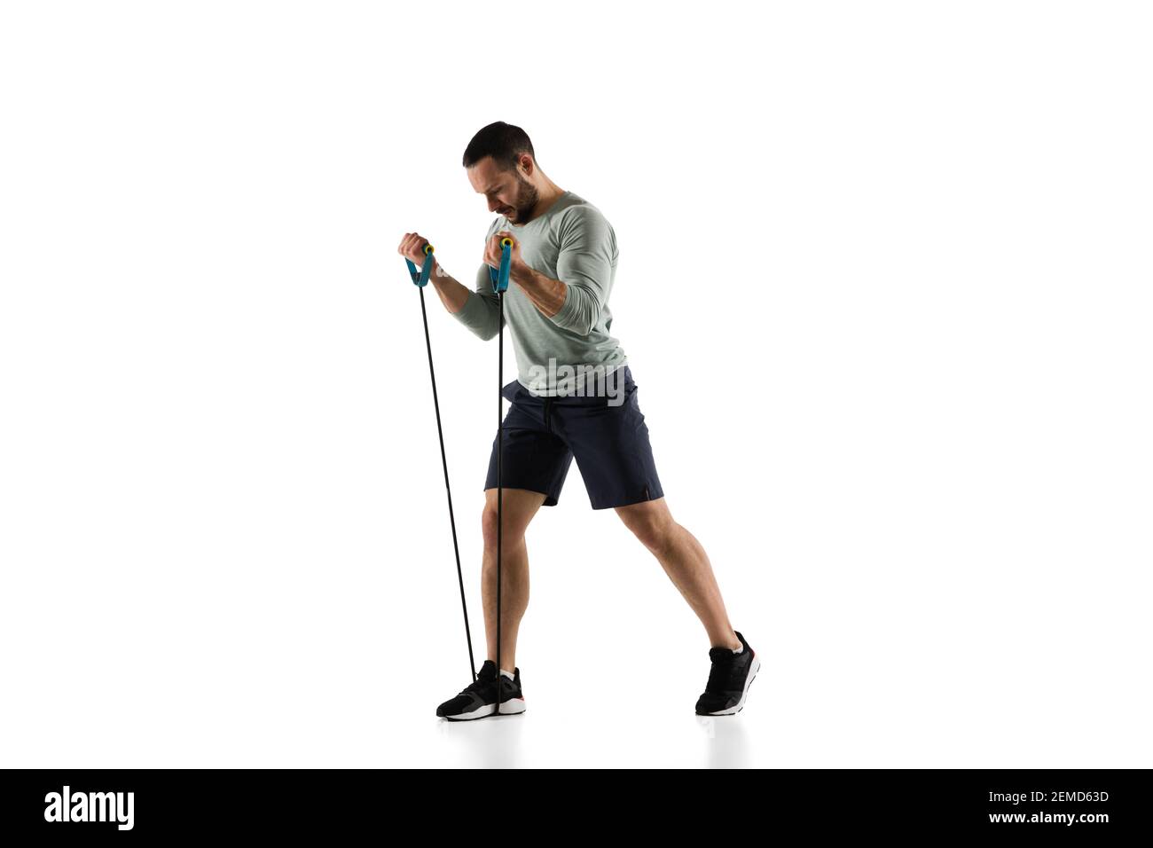 Jumping-rope. Young caucasian male model in action, motion on white ...