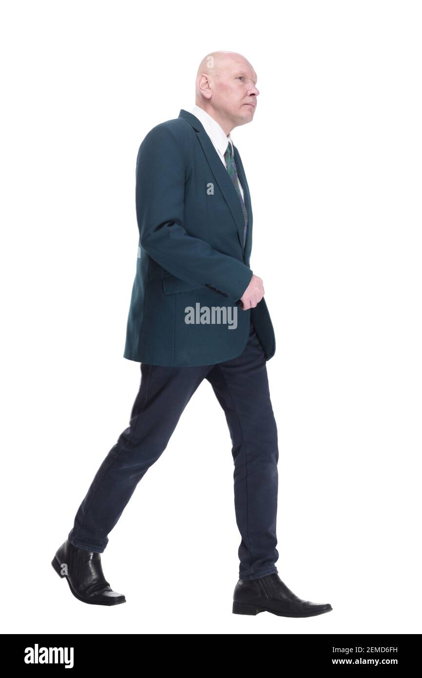 Mature business man striding forward. isolated on a white background ...