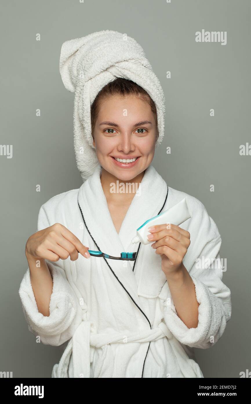 Smiling spa woman brushing her teeth with toothpaste Stock Photo - Alamy