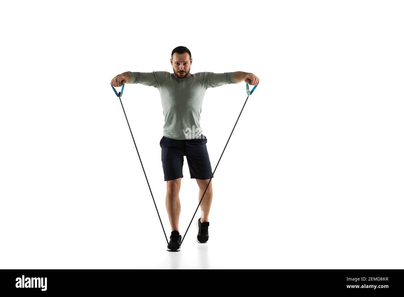 Jumping-rope. Young caucasian male model in action, motion on white ...