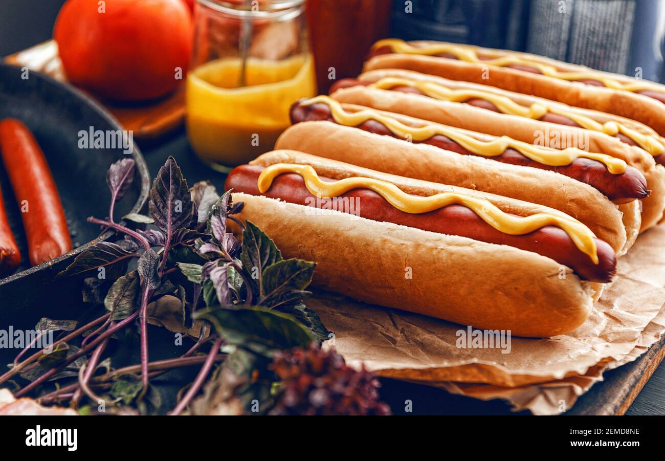 Barbecue Grilled Hot Dogs with yellow American mustard, On a dark ...