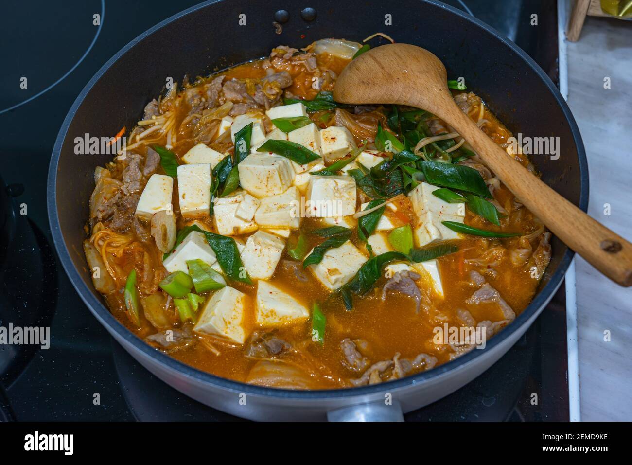 Spicy homemade Korean kimchi jjigae soup in the pan Stock Photo - Alamy