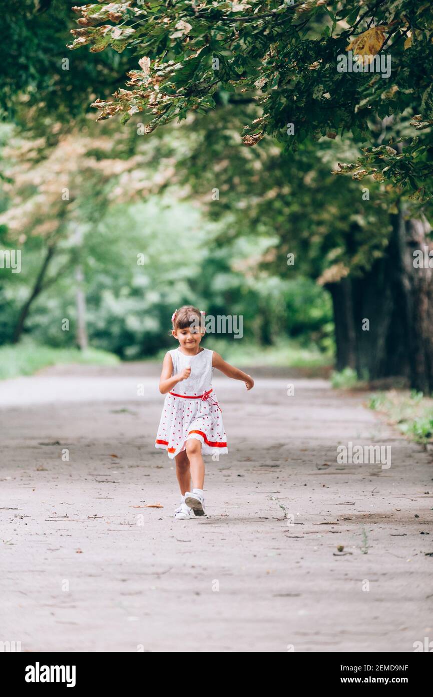 Little girl is running around Stock Photo - Alamy