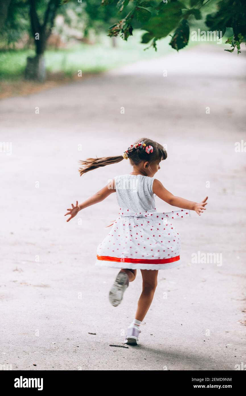 Little girl is running around Stock Photo - Alamy
