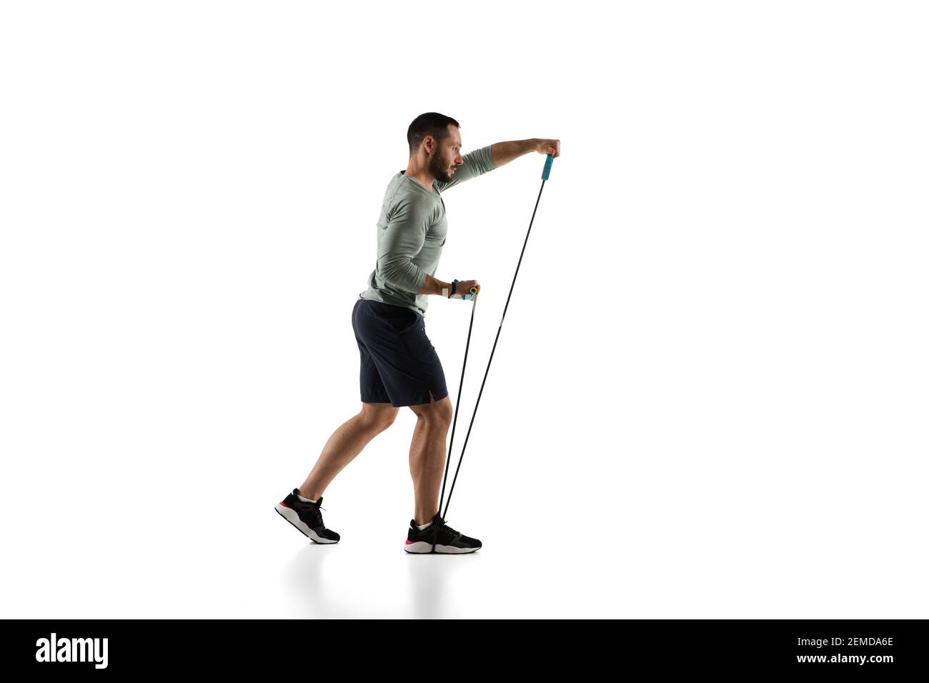 Jumping-rope. Young caucasian male model in action, motion on white ...