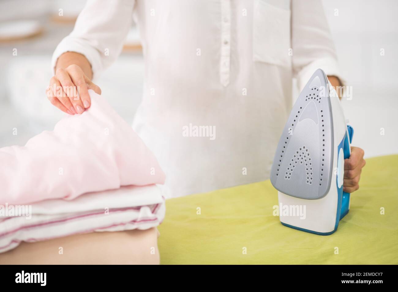 Close up picture of iron and clothes for ironing Stock Photo - Alamy