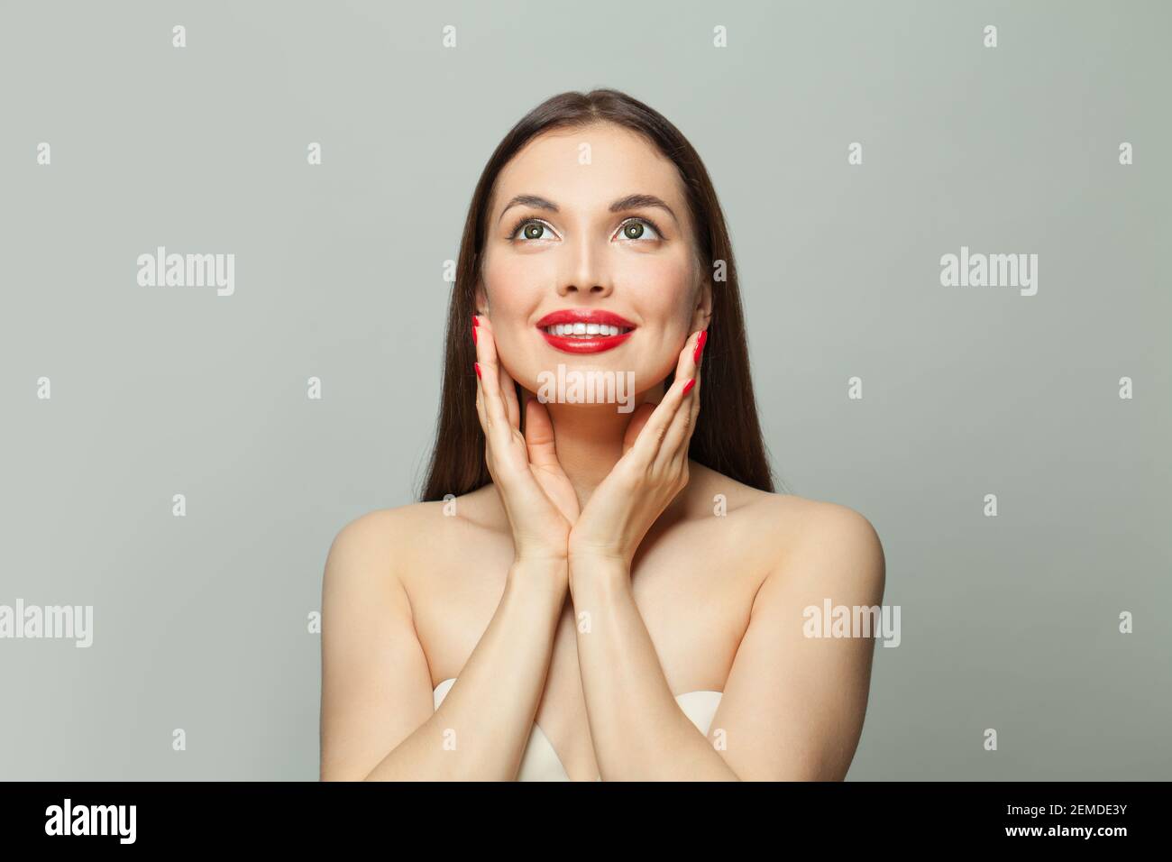 Cute young woman with clear skin and long healthy straight hair on ...