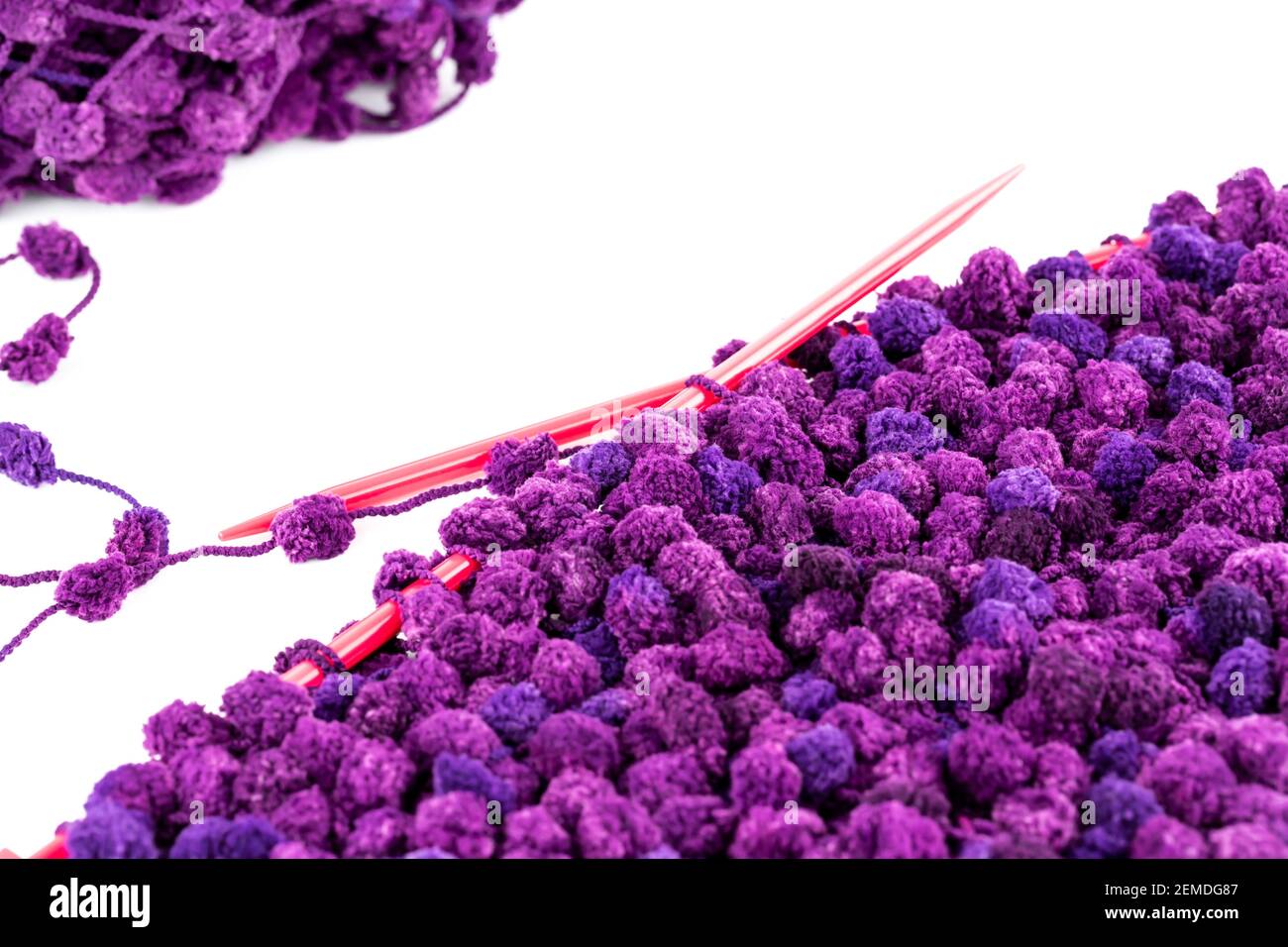 Purple yarn with knitting needles on white background Stock Photo - Alamy
