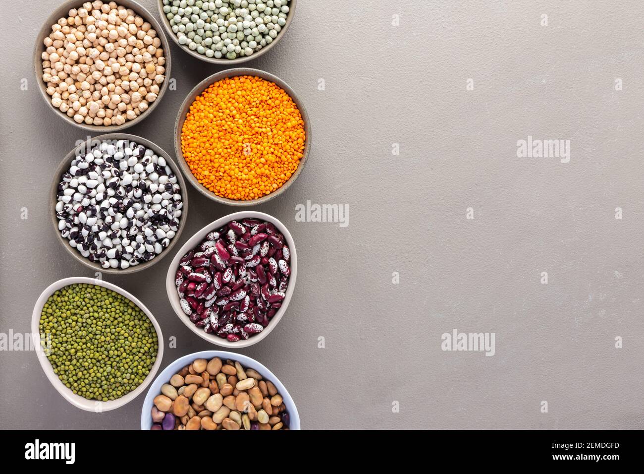 Different types of legumes in bowls, green and yellow peas, chickpeas ...
