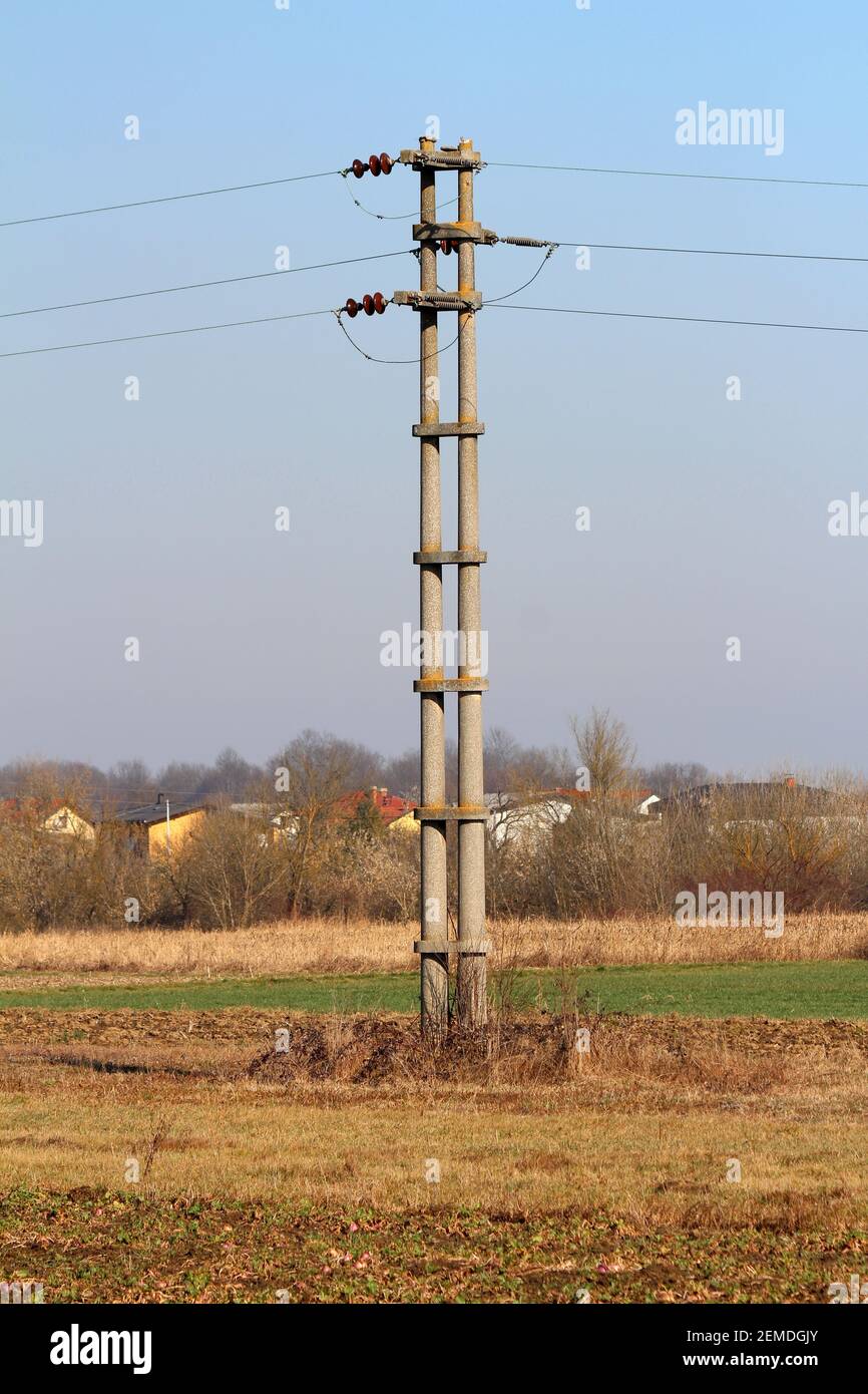 Old style double concrete electrical power line utility pole with dark ...