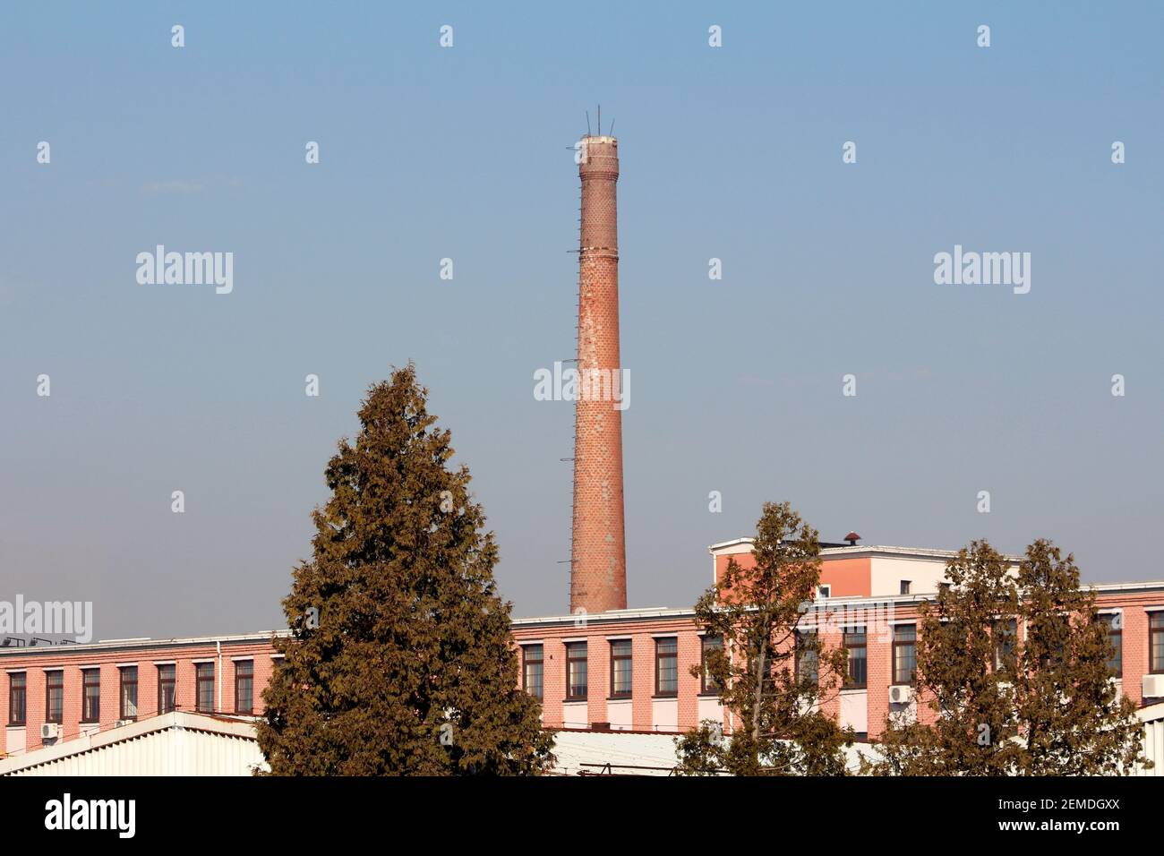 Red bricks tall industrial chimney with metal stairs mounted on side ...