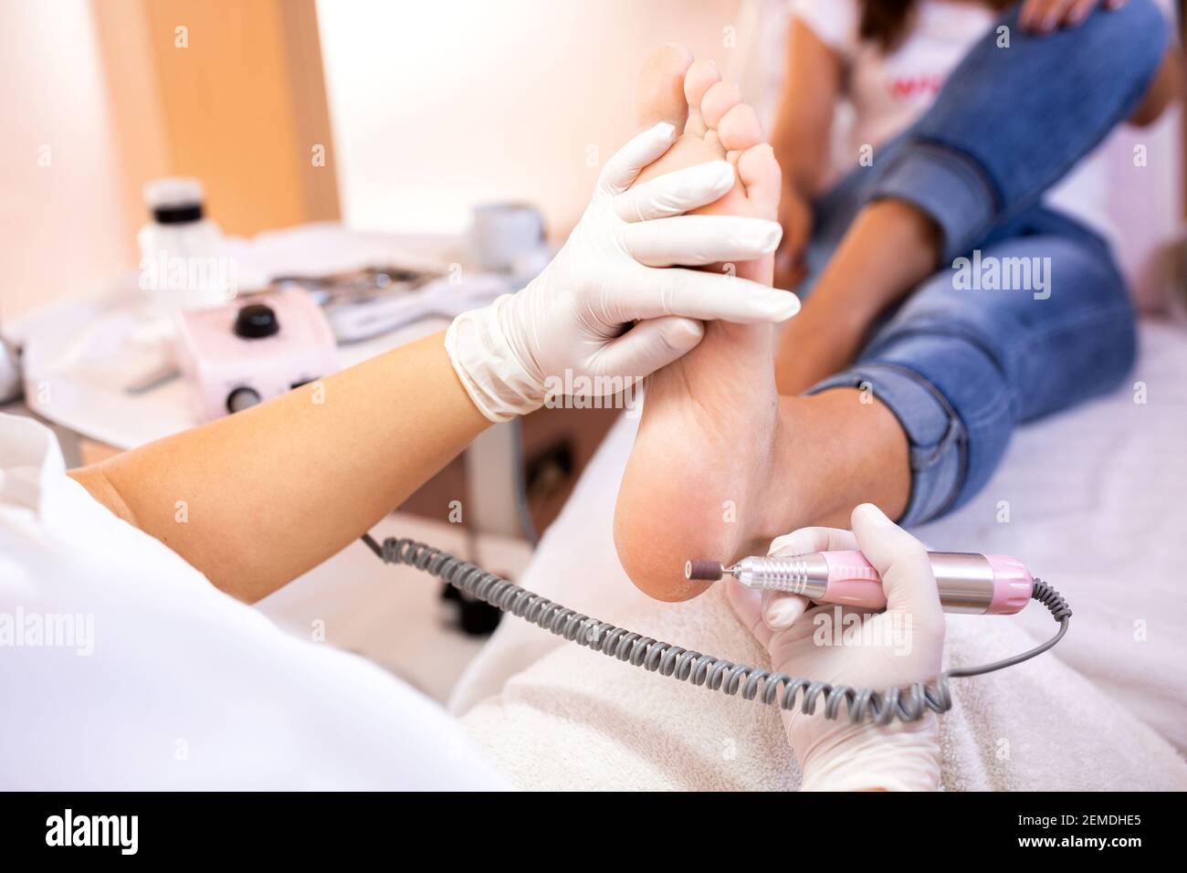 Pedicure treatment of heel skin area with electric rotating file Stock ...
