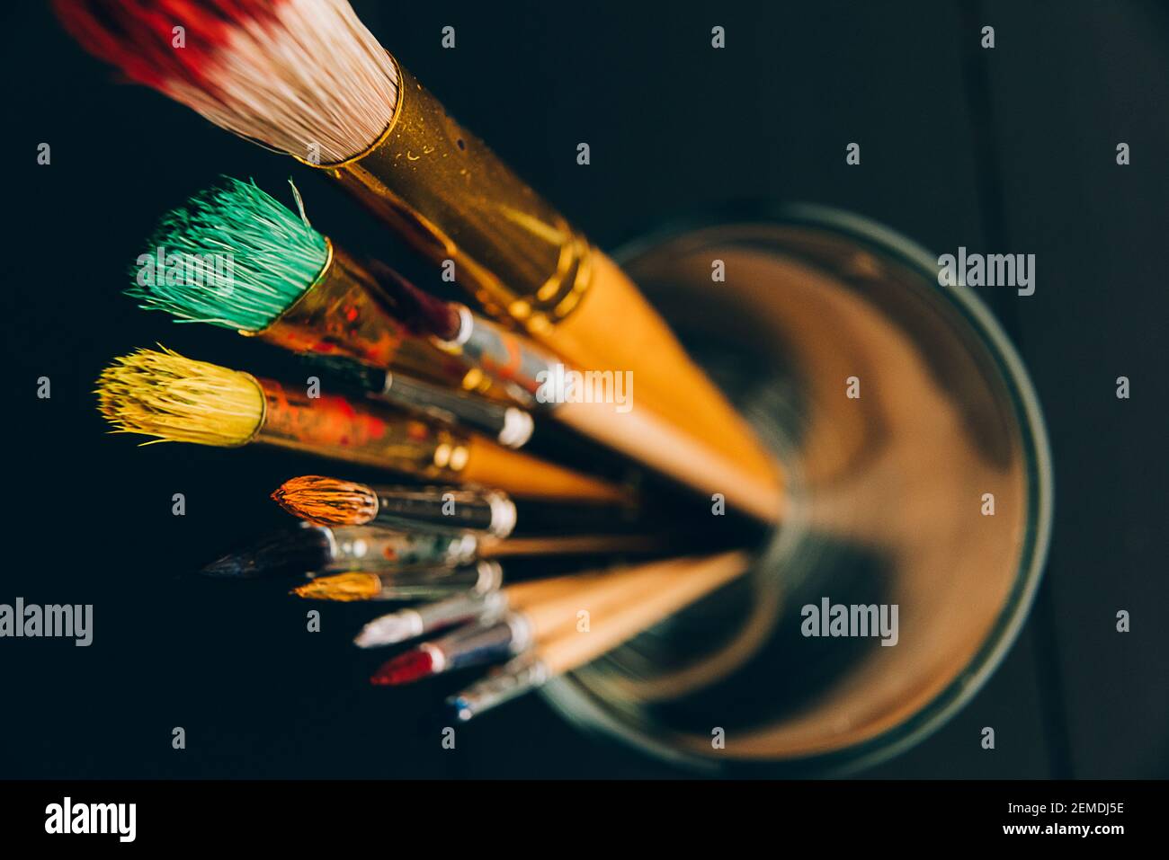 Artistic brushes with traces of paint on a dark background with a shallow depth of field Stock ...
