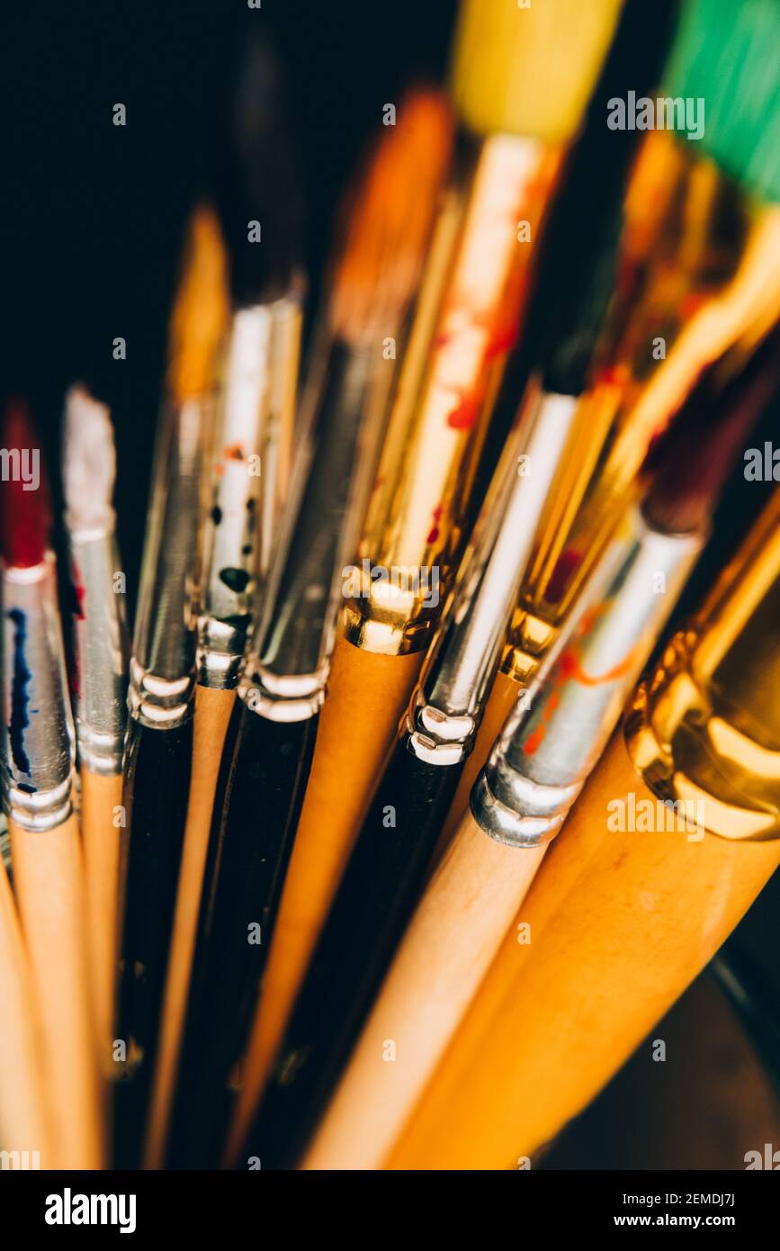 Artistic brushes with traces of paint on a dark background with a shallow depth of field Stock ...