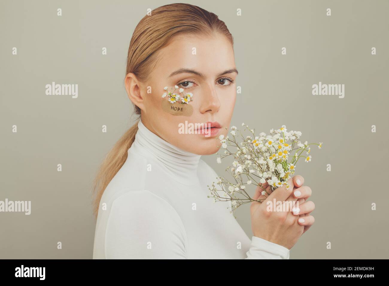 Hope. Beautiful woman with flowers daisy on white background portrait ...