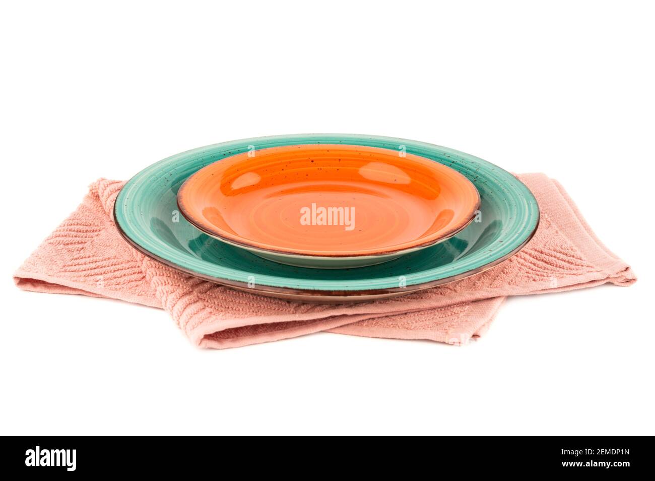 Two empty plates on pink cotton towel isolated on white background ...