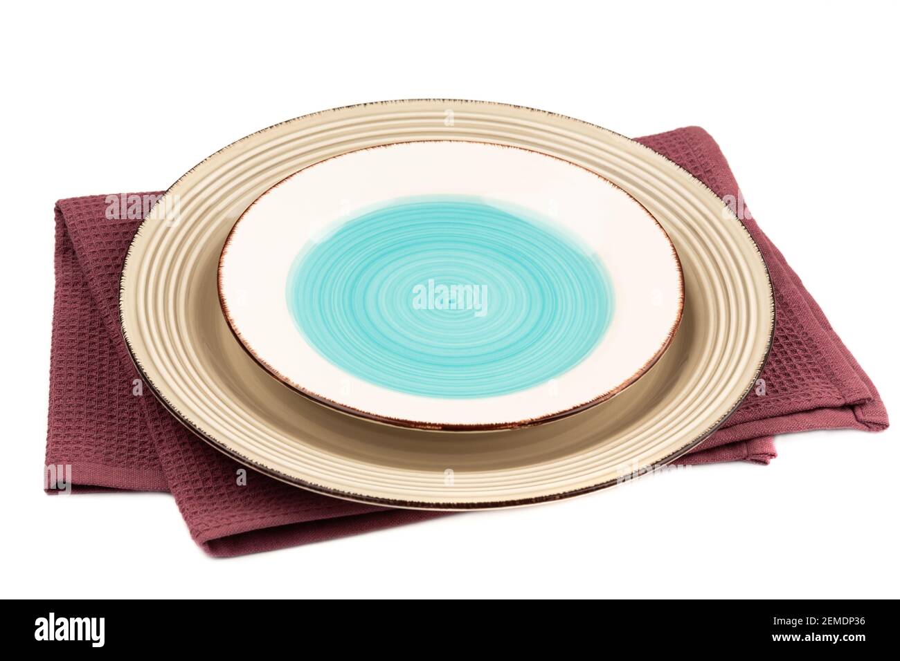 Two empty plates on purple cotton towel isolated on white background ...