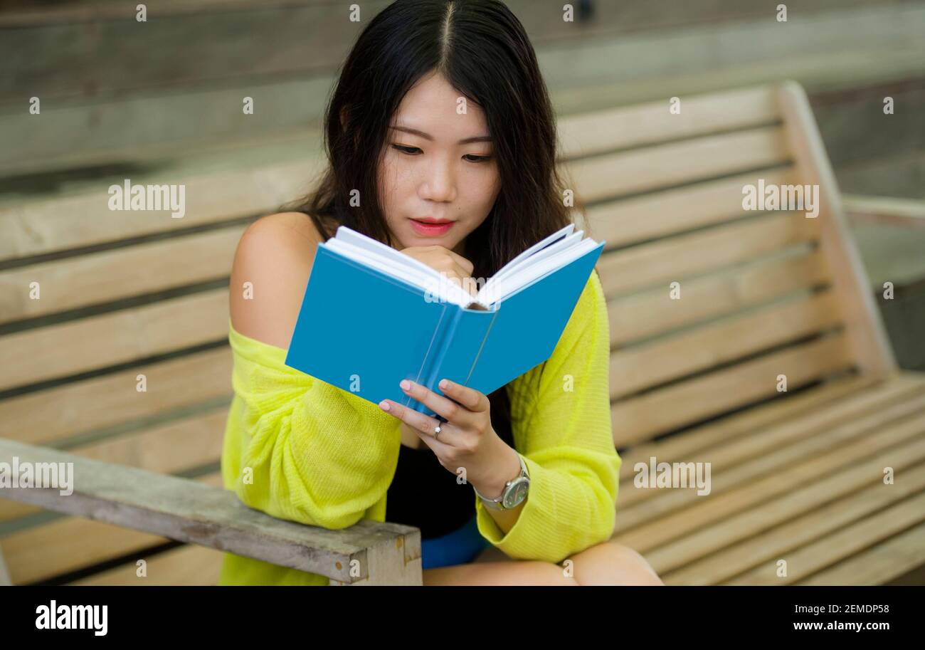 Asian woman reading book - lifestyle portrait of young beautiful and ...