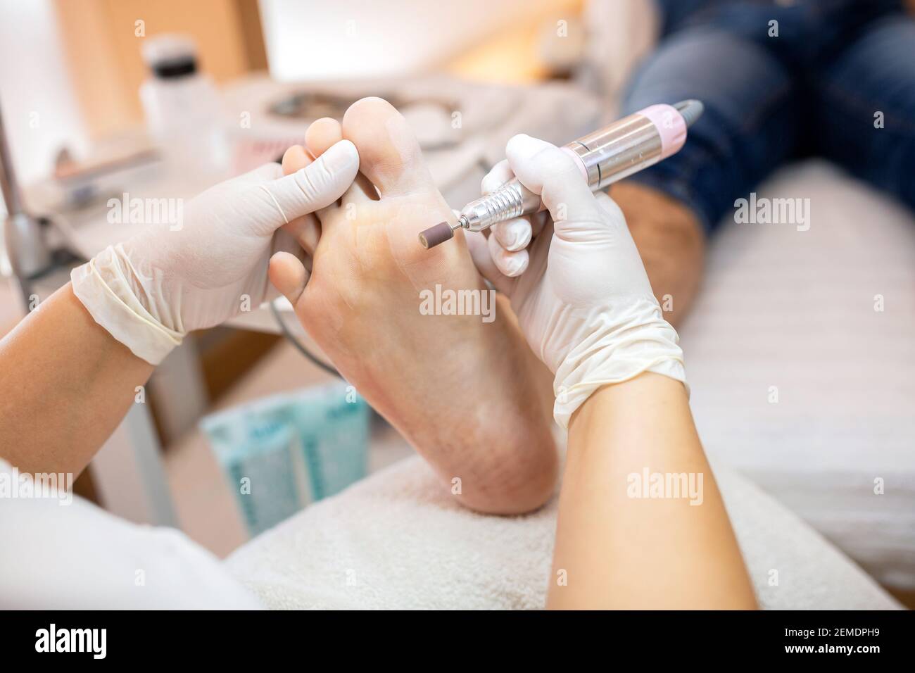 Foot pedicure treatment, big toe skin area, rotating skin pedicure file ...